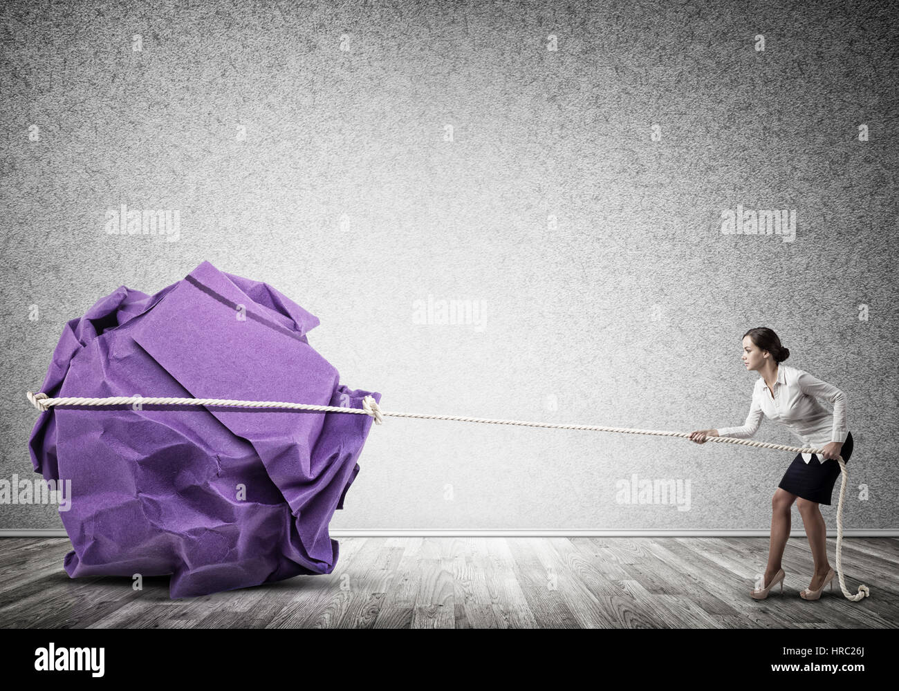 Young woman making huge paper ball move Stock Photo - Alamy