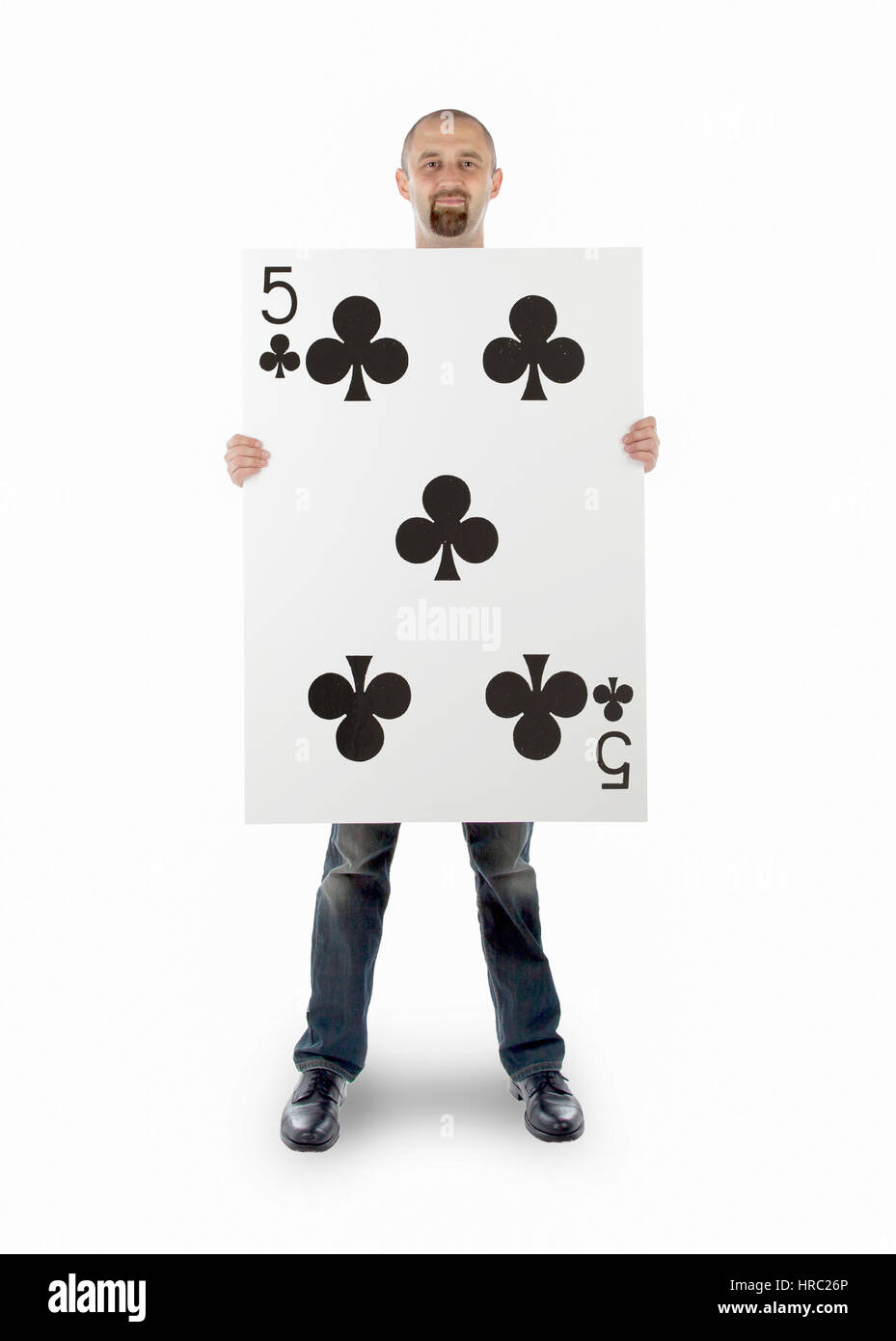Businessman with large playing card - Five of clubs Stock Photo - Alamy