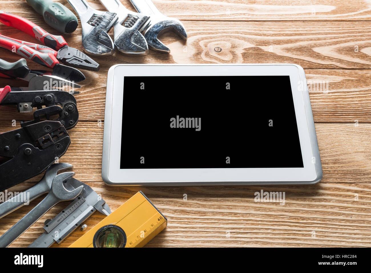 Variety of tools of builder and tablet pc on wooden texture table Stock ...