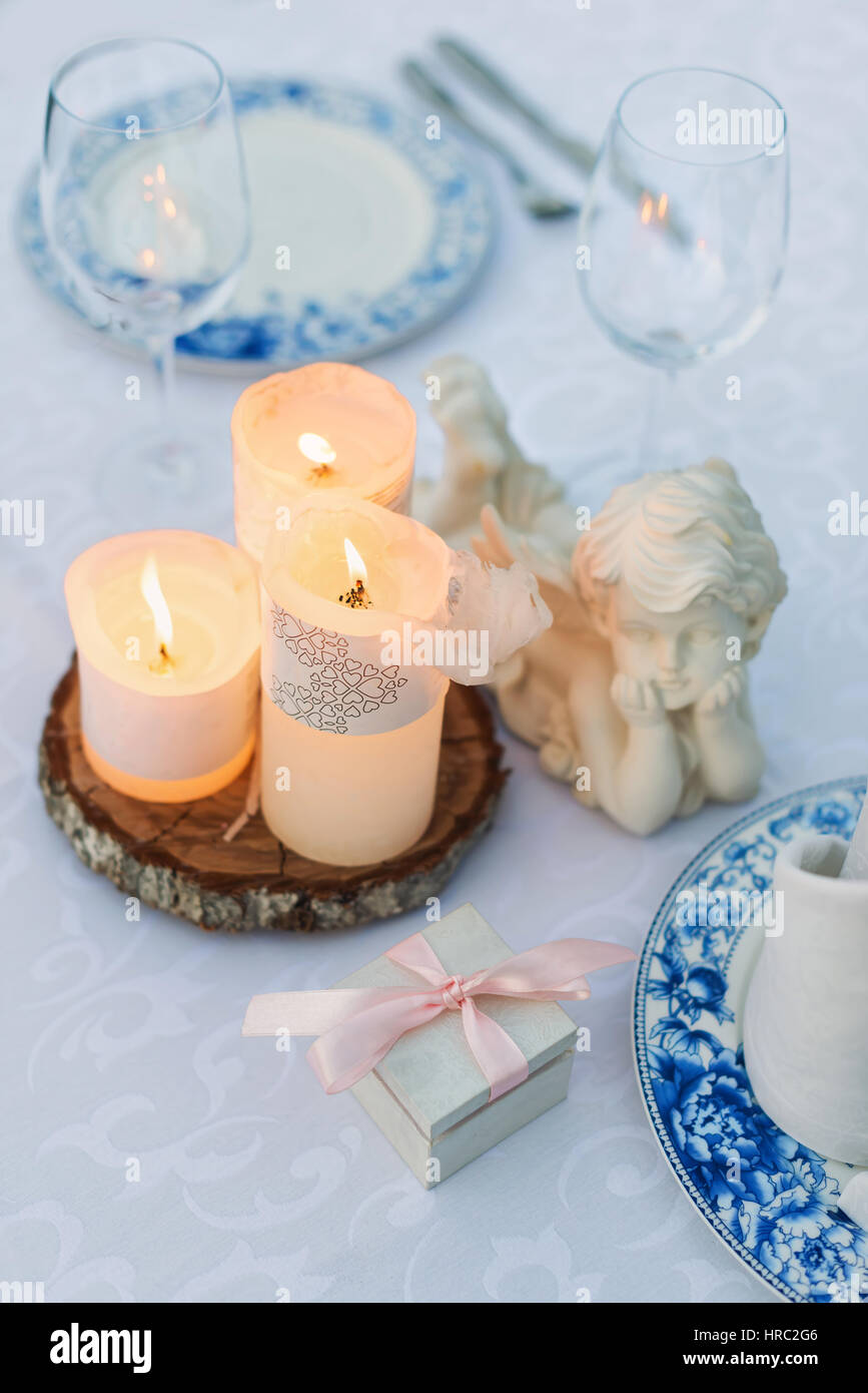 Table decorated with candles and angels for wedding or romantic dinner ...
