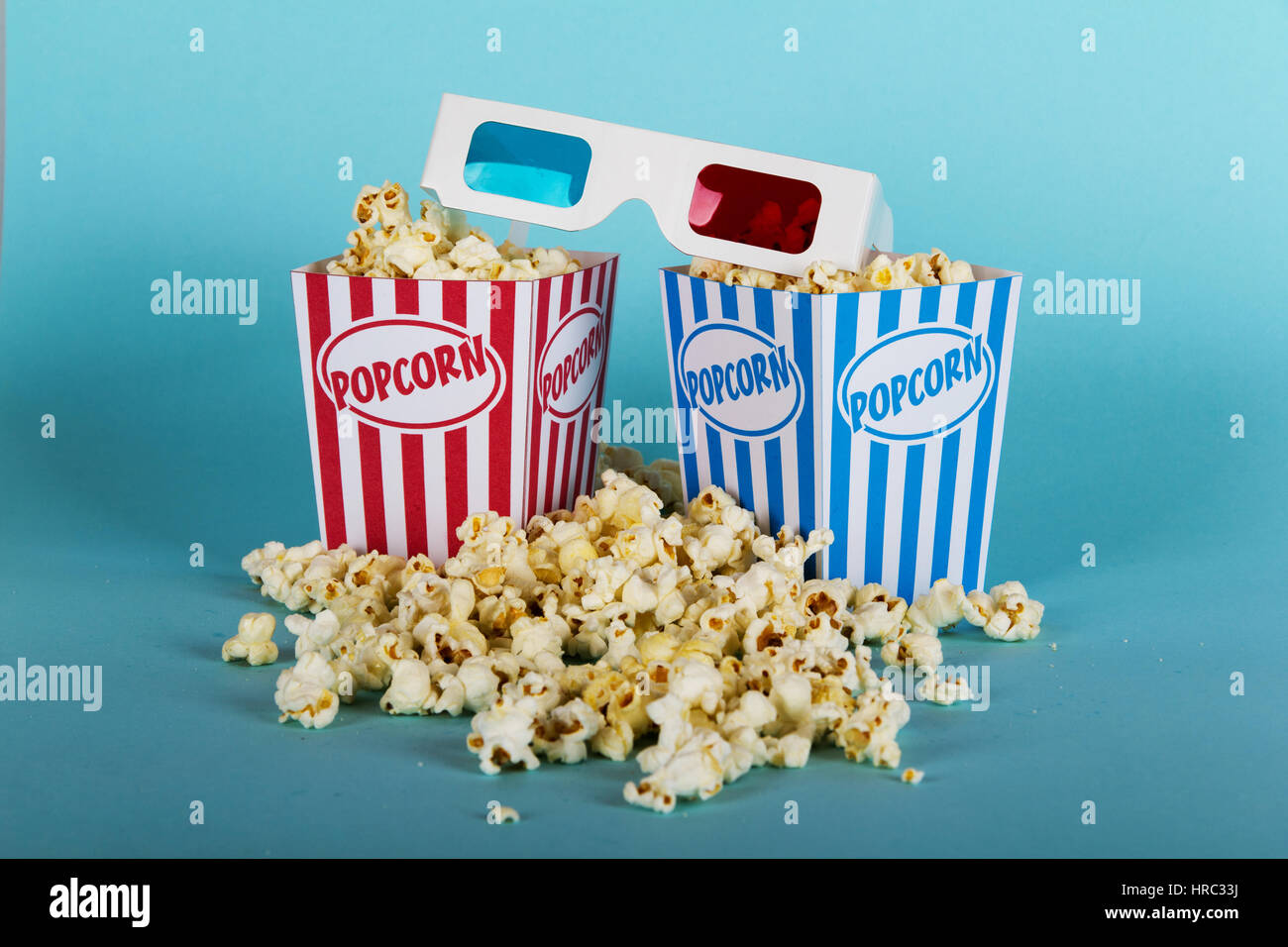 Bucket of popcorn against a blue background Stock Photo - Alamy