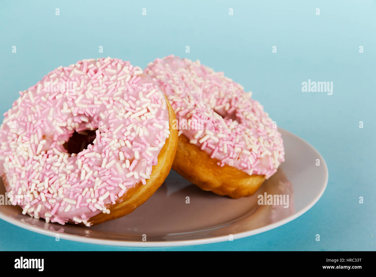 Iced doughnut on a light coloured blue background Stock Photo - Alamy