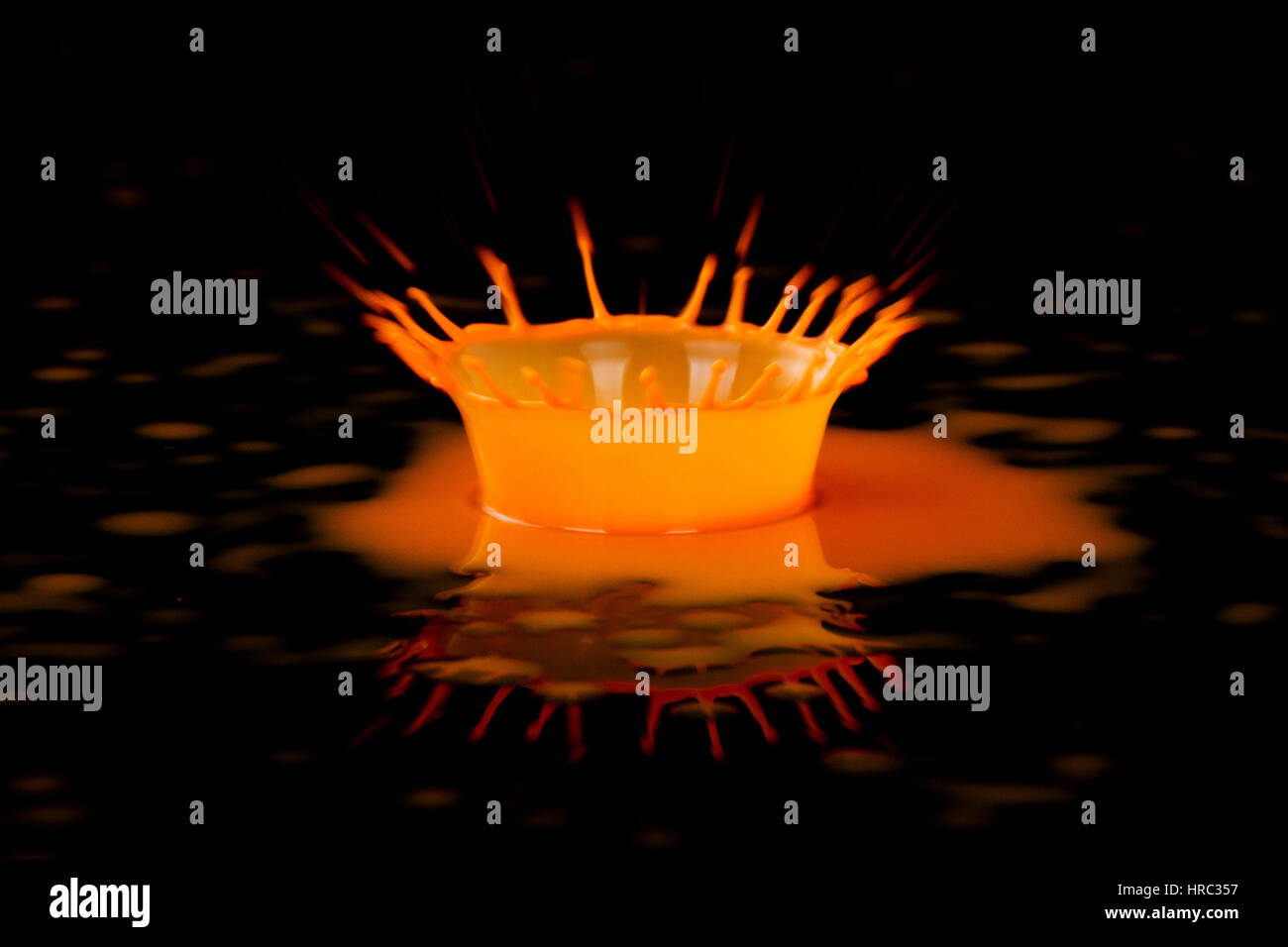 Colorful paint drop splashing on black a background Stock Photo - Alamy