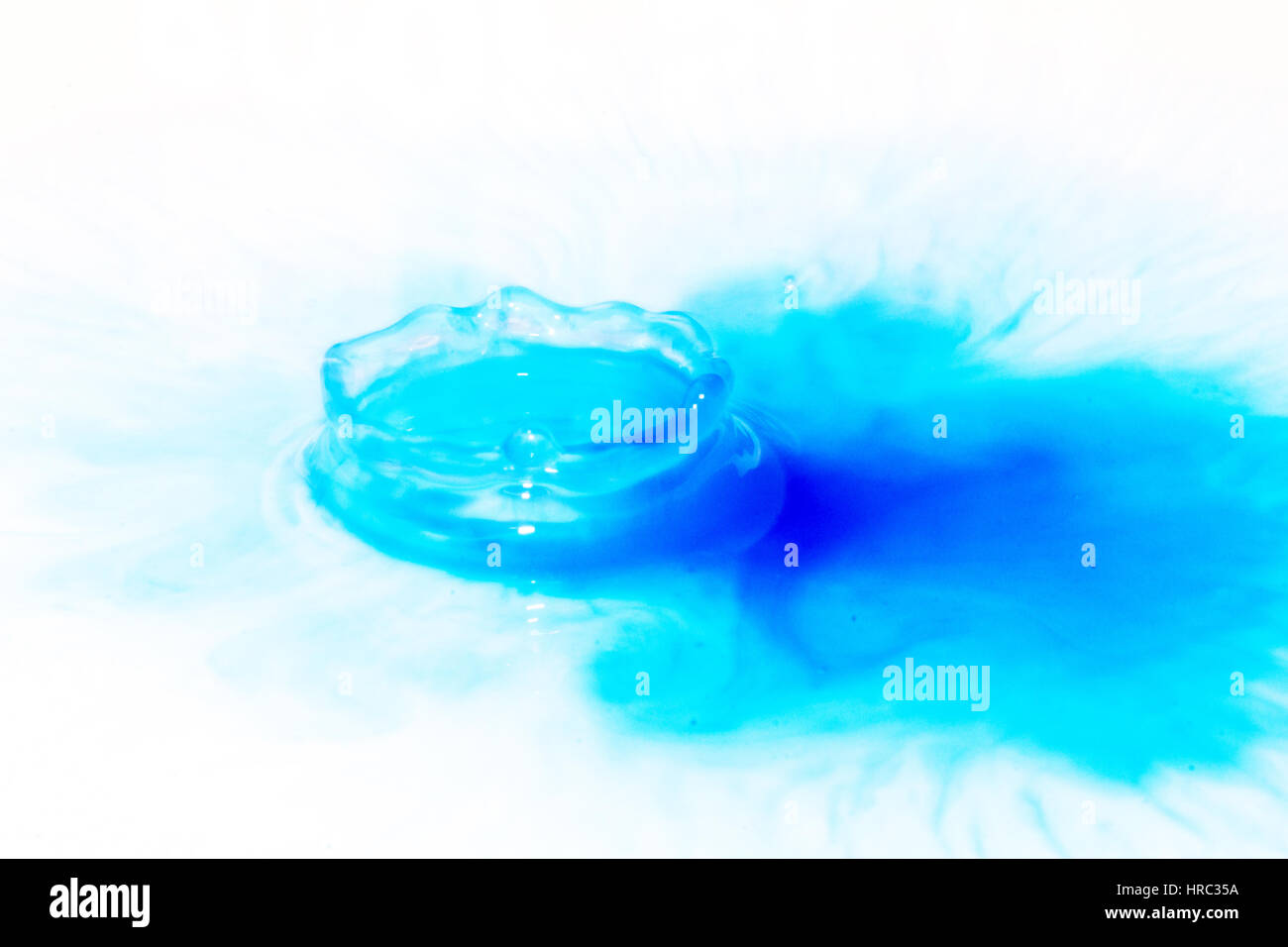 Colorful paint drop splashing on black a background Stock Photo - Alamy