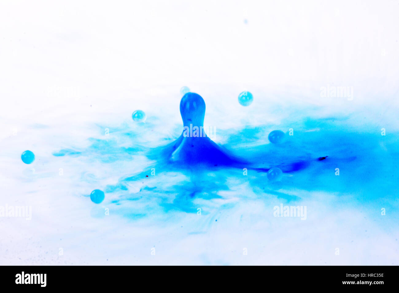 Colorful paint drop splashing on black a background Stock Photo - Alamy