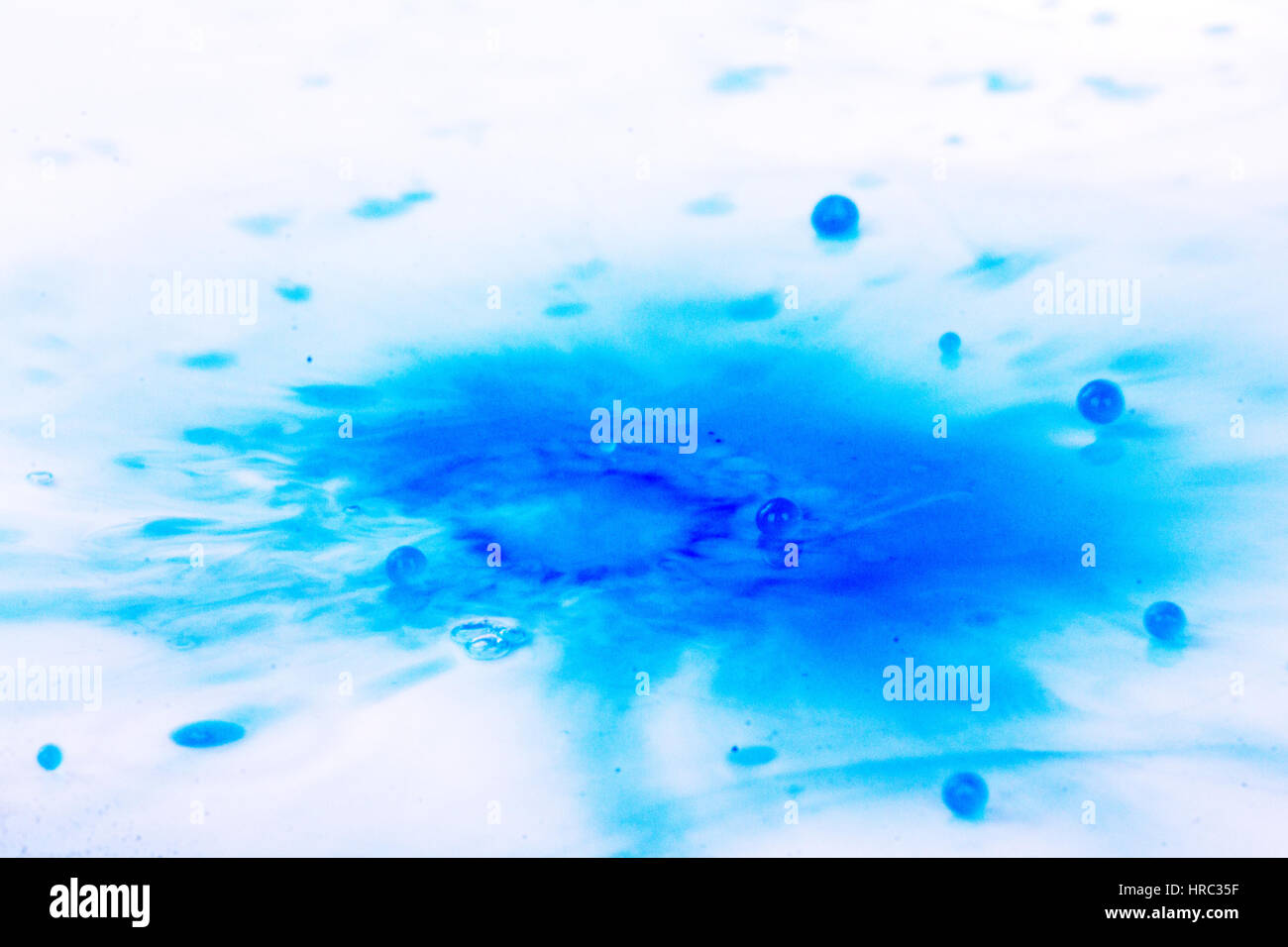Colorful paint drop splashing on black a background Stock Photo - Alamy