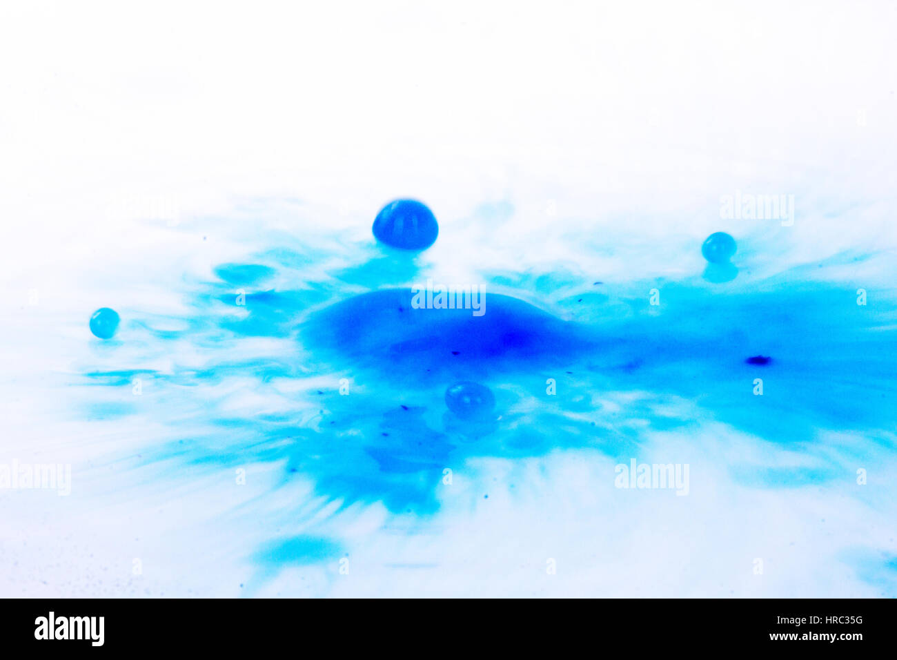 Colorful paint drop splashing on black a background Stock Photo - Alamy