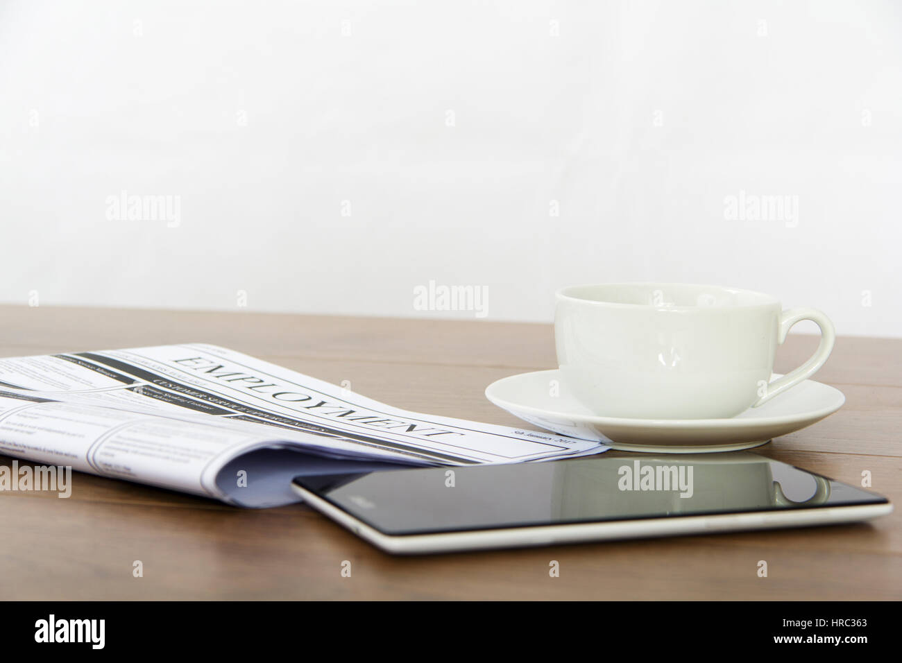 Searching for a new job or employment in a newspaper Stock Photo - Alamy