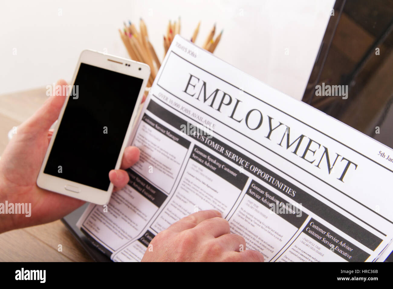 Searching for a new job or employment in a newspaper Stock Photo - Alamy