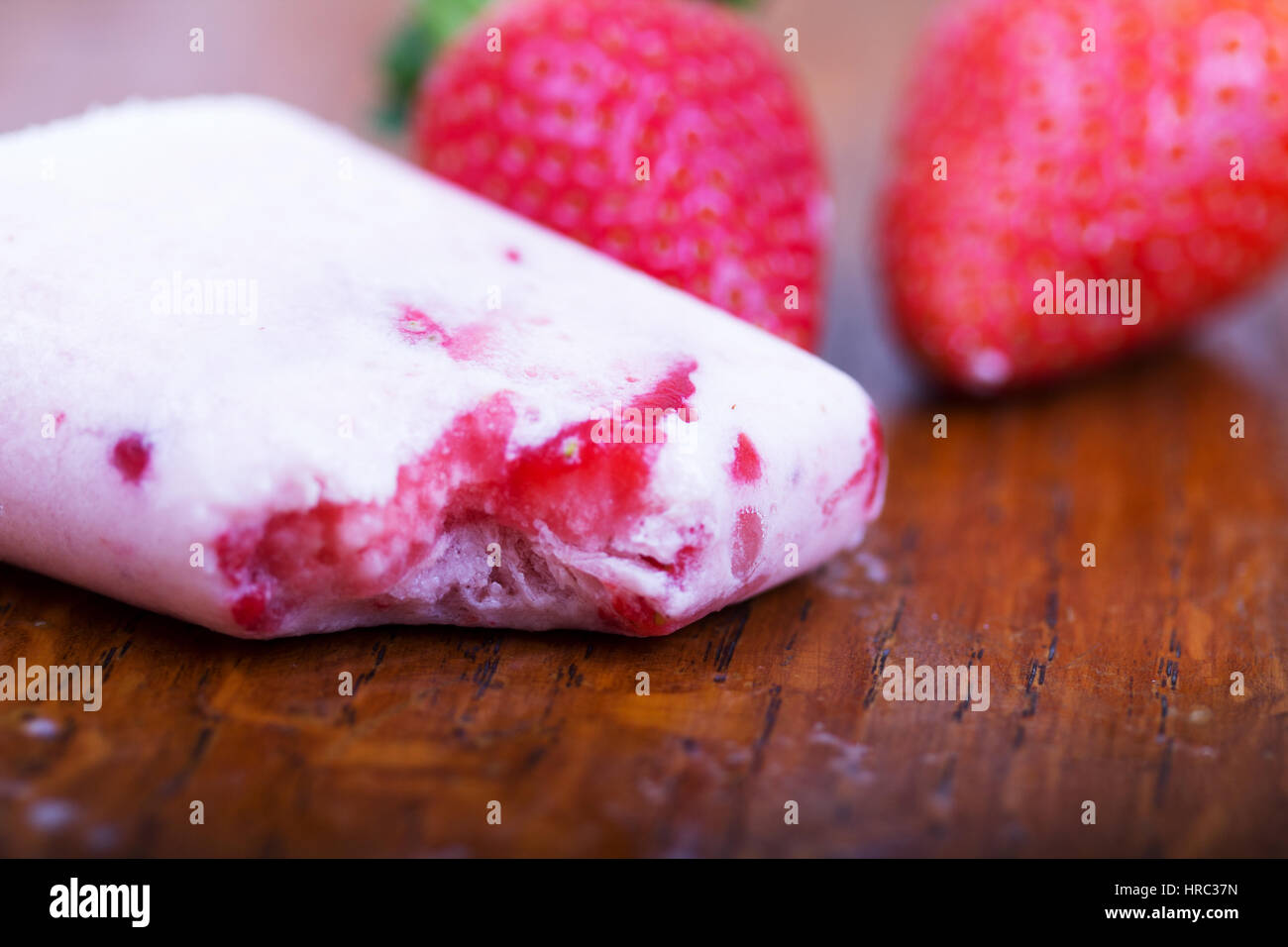 Homemade strawberry ice lolly on a rustic background Stock Photo - Alamy