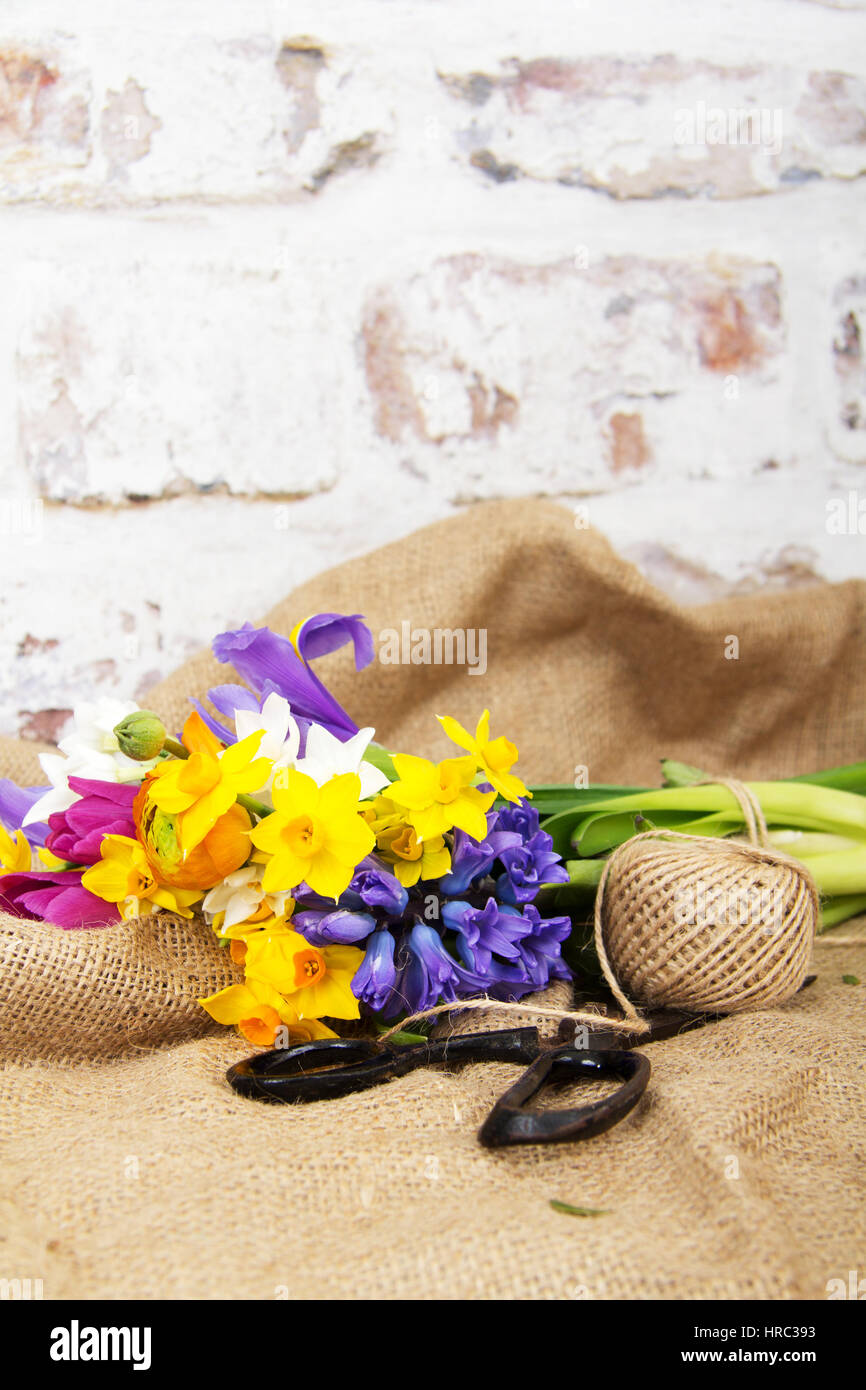 Spring cut flower arrangement against a rustic background Stock Photo ...