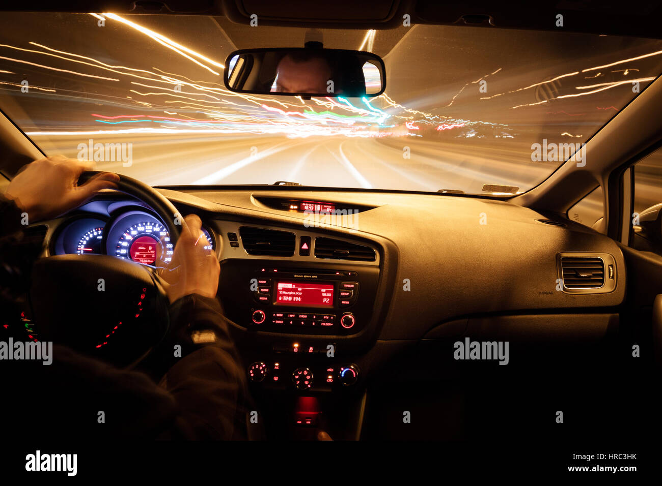 Night driving, view from inside car, city and other cars light is ...