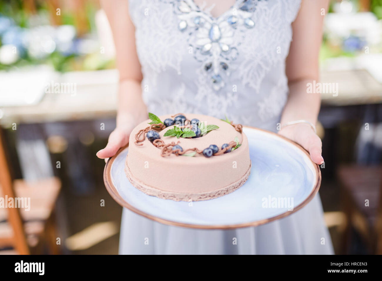 bride holding delicious creamy cake in hands closeup Stock Photo - Alamy