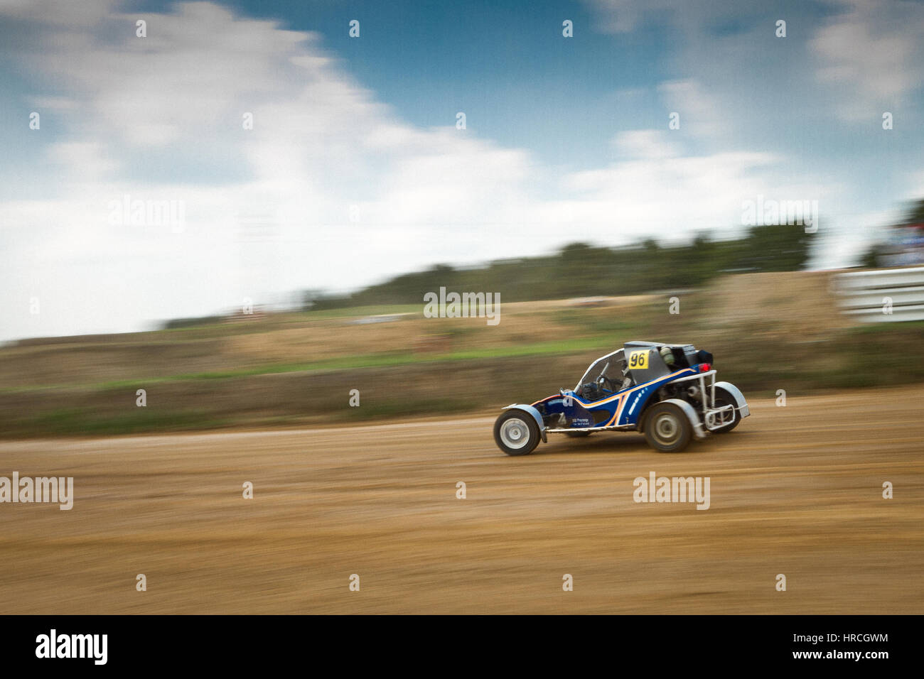Blue buggy racing car on dry dirt road, high speed shot with blur ...
