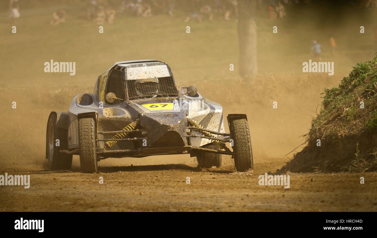 Low blue buggy racing car in action, drifting while passing the corner ...