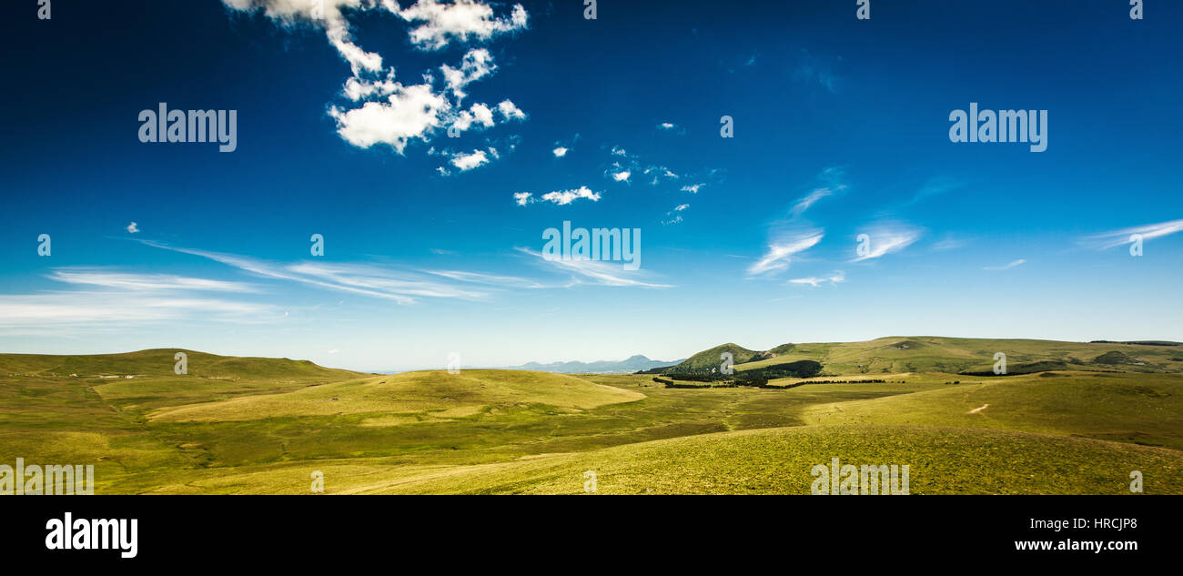 Lush green countryside and rolling hills, Auvergne, France in a ...