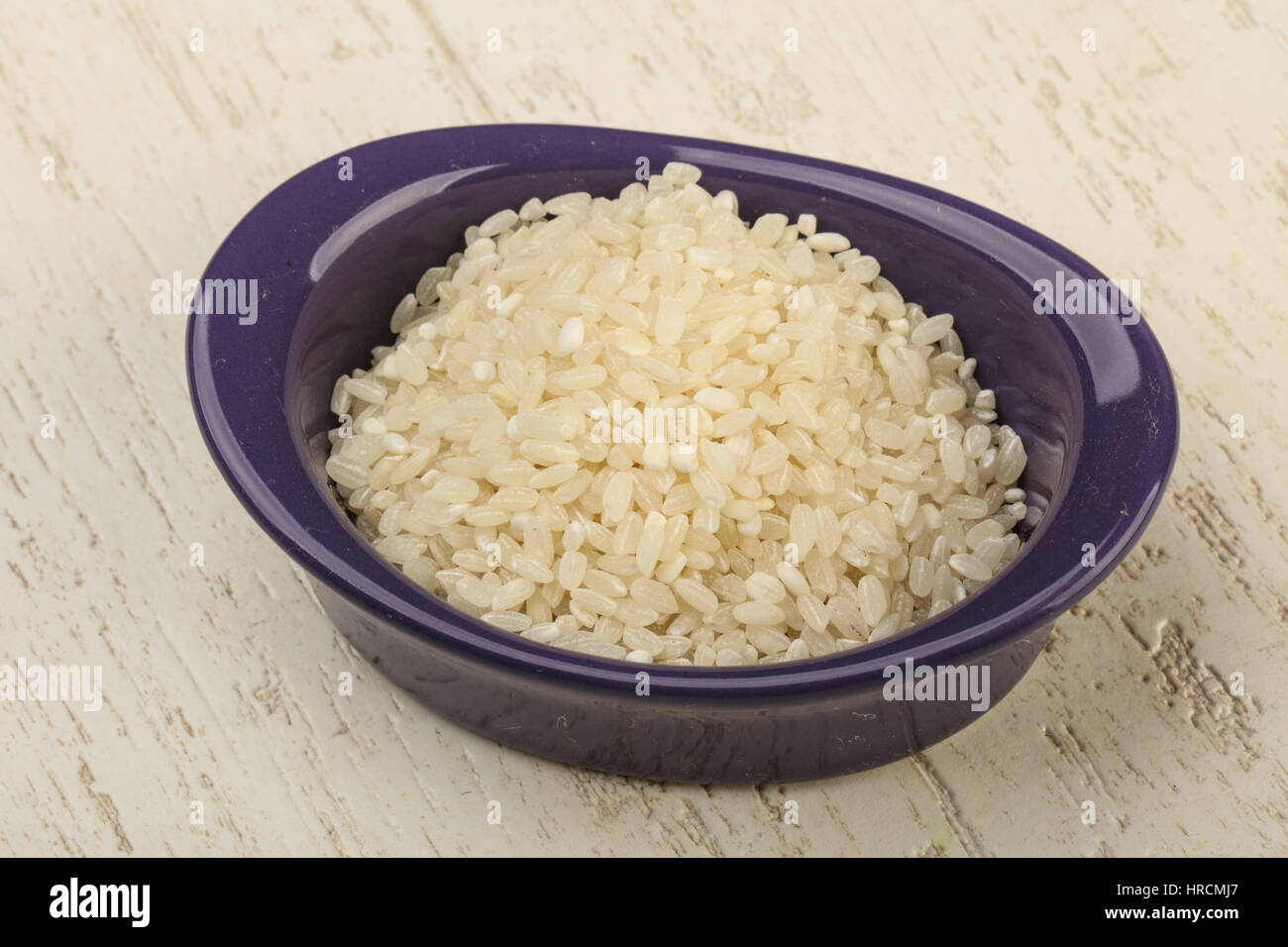 Raw rice heap in the bowl - ready for cooking Stock Photo - Alamy