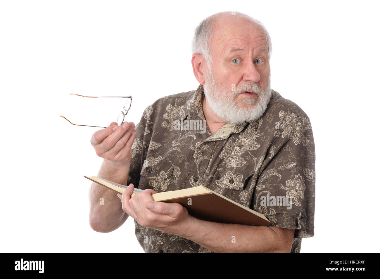 Handsome Bald And Bearded Senior Man Distracted When Reading A Book