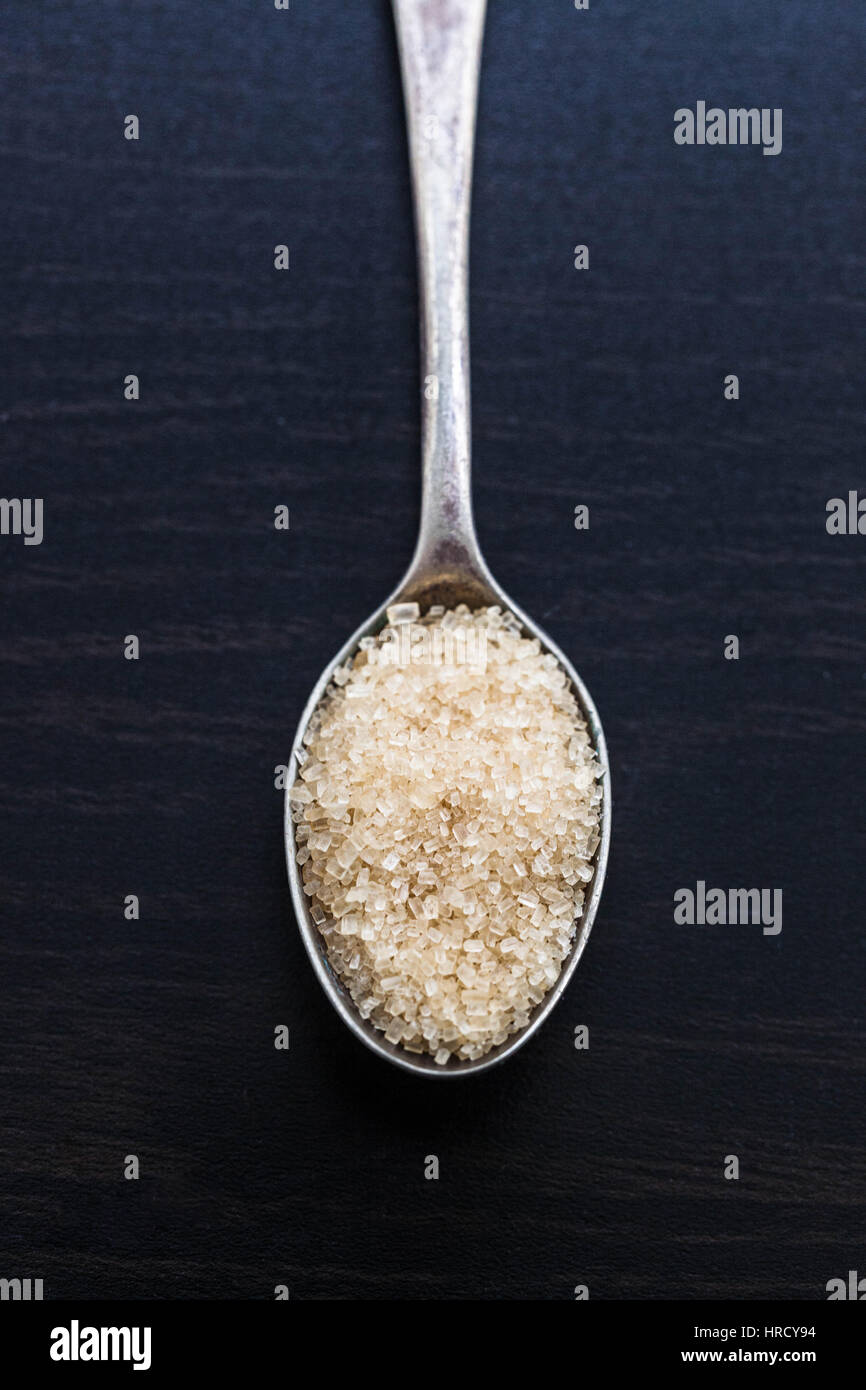 High angle close up of a teaspoon with brown sugar Stock Photo - Alamy