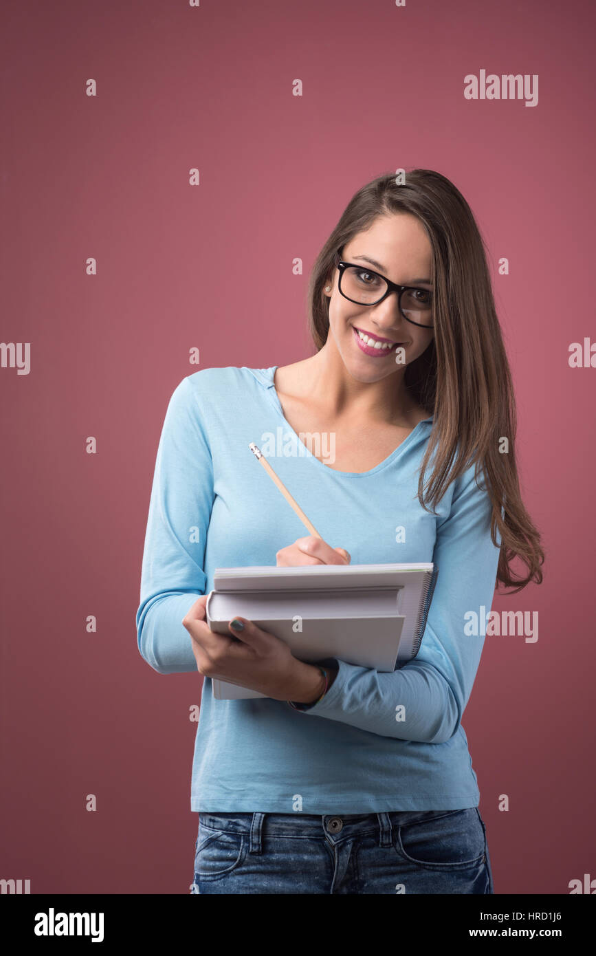 Smart beautiful student girl with glasses holding textbooks Stock Photo ...
