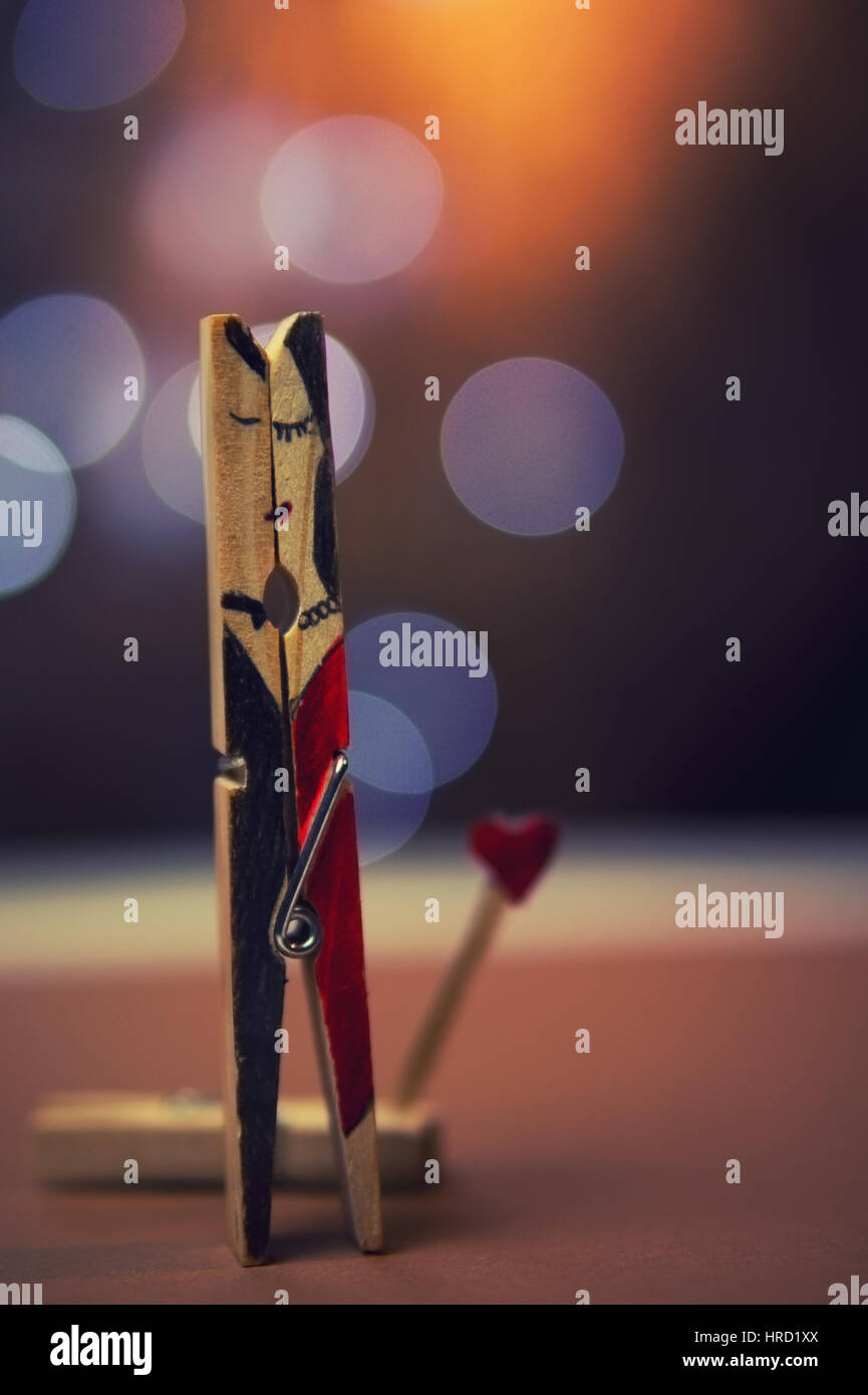 Clothespin lovers on a romantic picture. Color effects and custom white ...