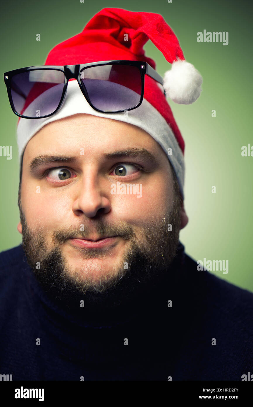 Crazy man with beard and in a red christmas hat. Color effects and ...