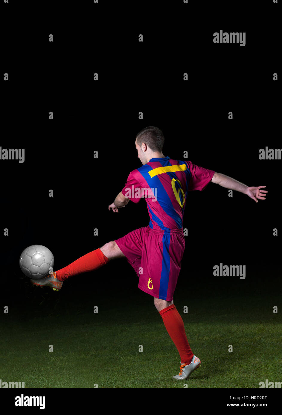 soccer player doing kick with ball on football stadium field Stock ...
