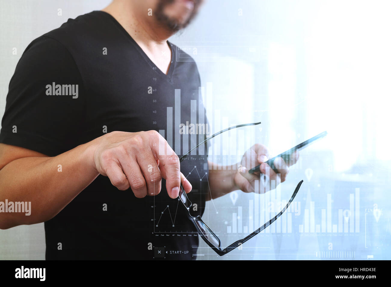 Designer hand holding eyeglasses,using smart phone,virtual computer ...