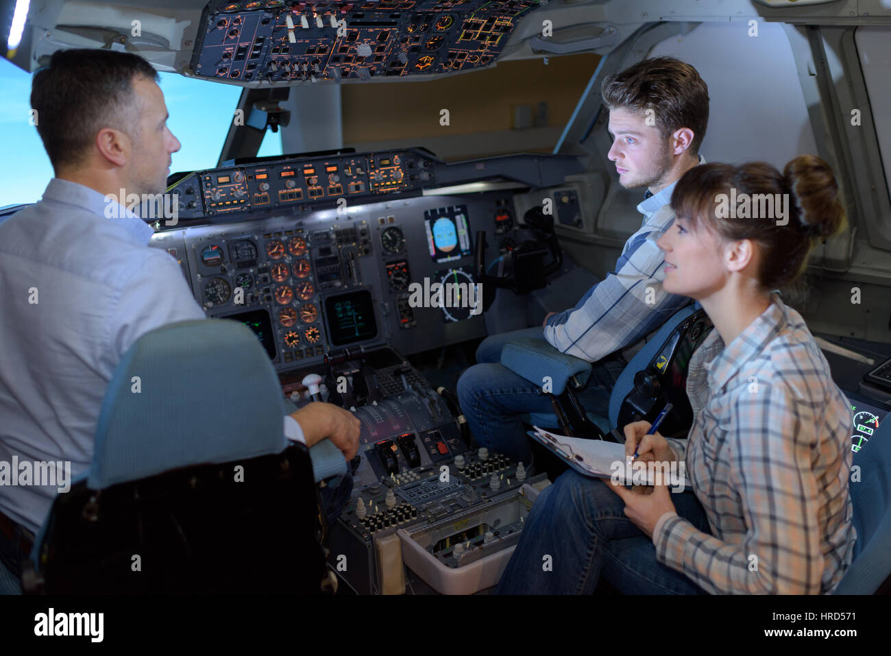 Young people in aircraft cockpit Stock Photo - Alamy