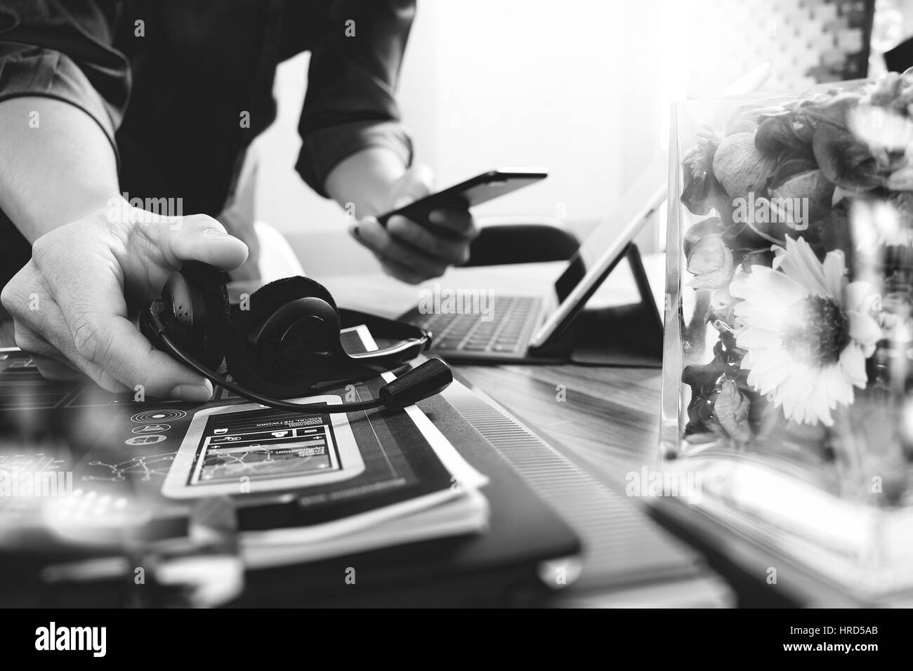 Man using voip headset with digital tablet computer docking keyboard hi ...