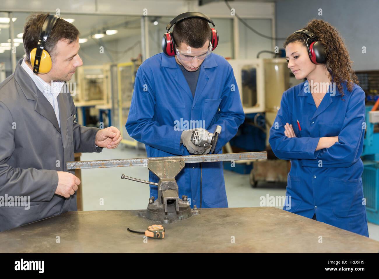 Student using angle grinder Stock Photo - Alamy