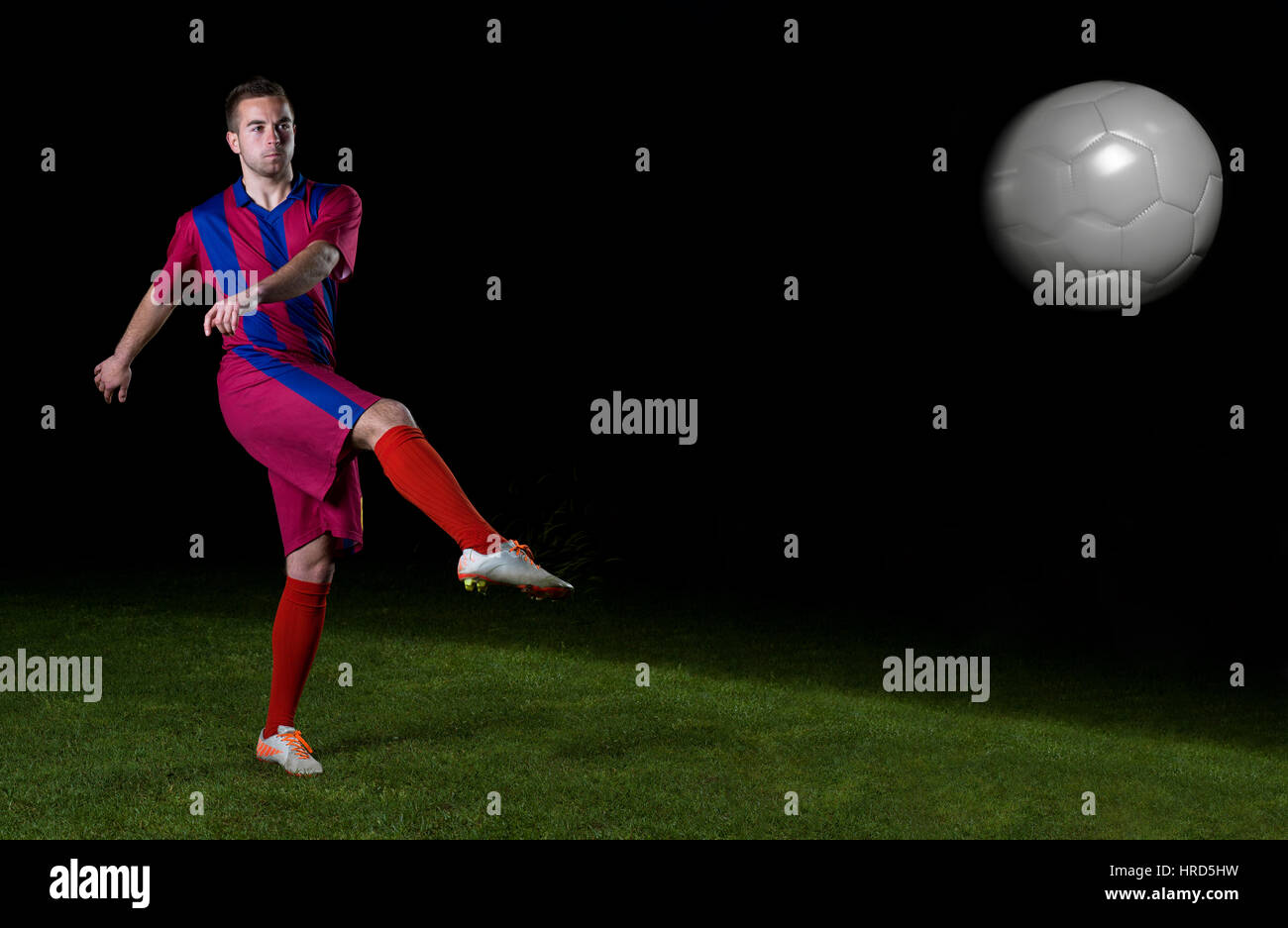 soccer player doing kick with ball on football stadium field Stock ...