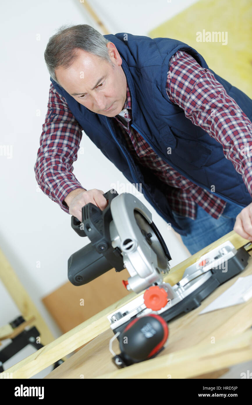 portrait of carpenter cutting wood using table saw Stock Photo - Alamy
