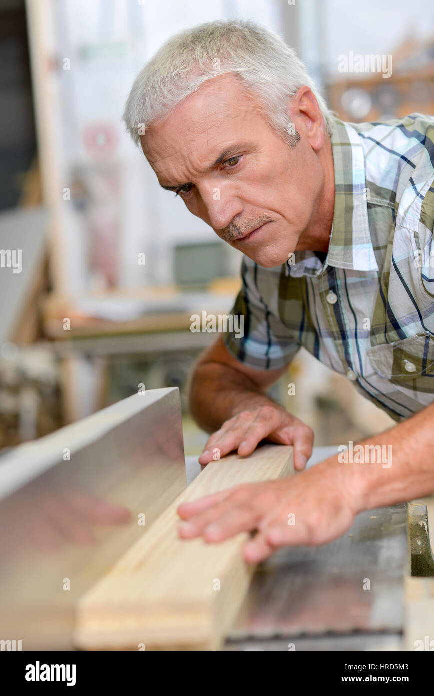 Concentrating whilst using a table saw Stock Photo - Alamy