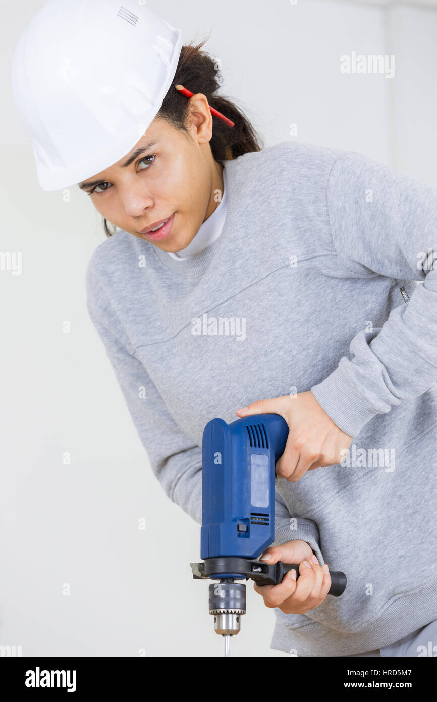 female worker using power tool to drill Stock Photo - Alamy