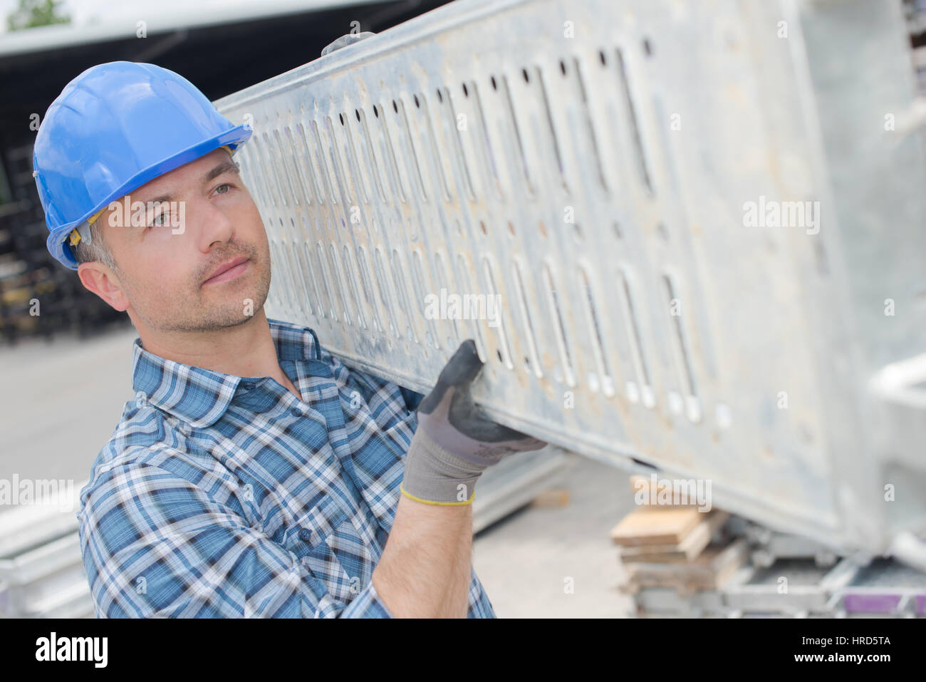 Man carrying metal beam hi-res stock photography and images - Alamy