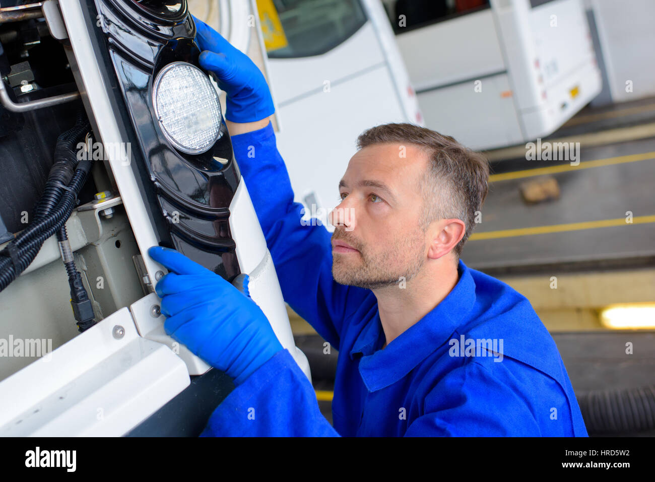 worker installing the bus light Stock Photo - Alamy