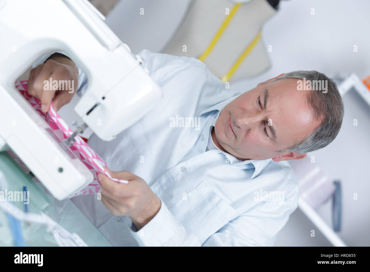 Man threading needle hi-res stock photography and images - Alamy