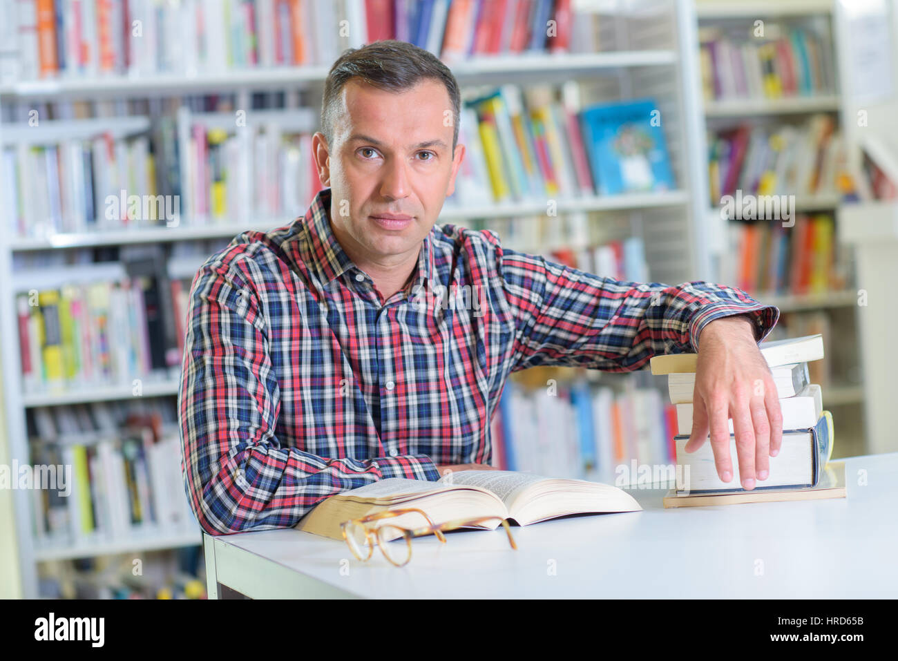 man with books posing Stock Photo - Alamy