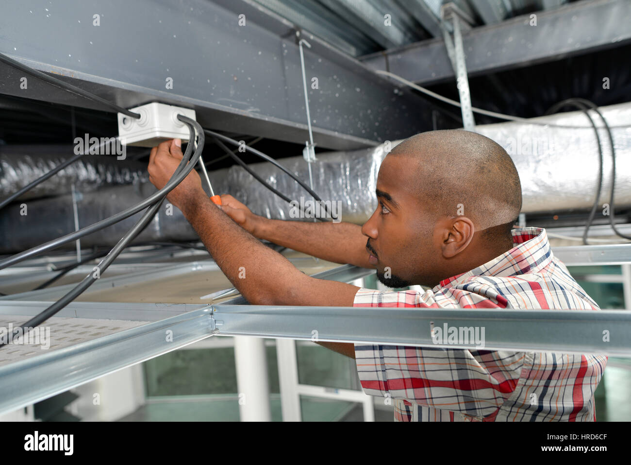 Electrician worked in a ceiling panel Stock Photo - Alamy