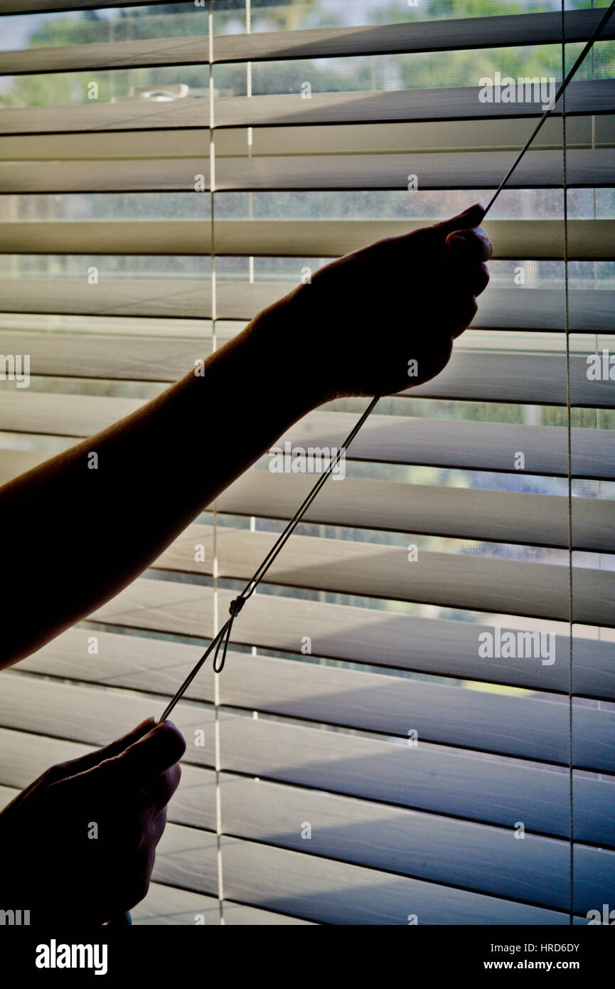 Hand opening window shutters Stock Photo - Alamy