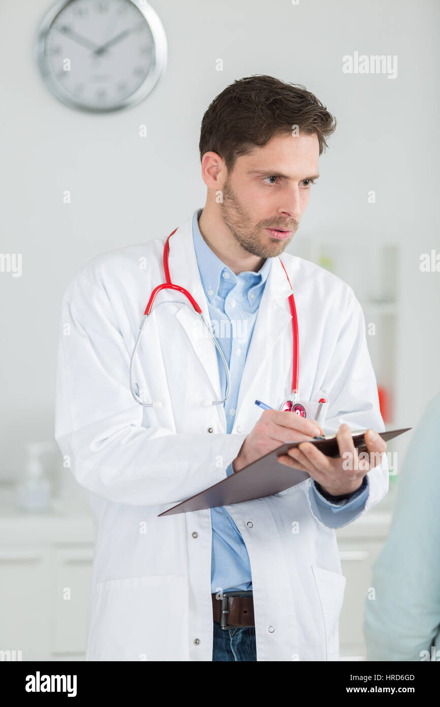 young doctor writing notes and prescriptions Stock Photo - Alamy