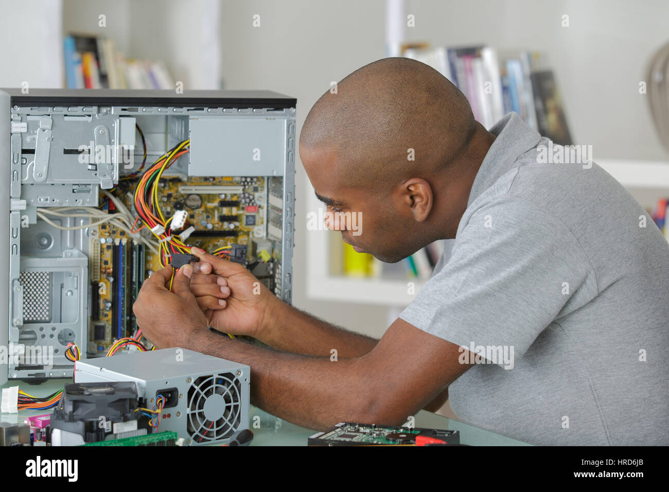Computer repairman examining cables Stock Photo - Alamy