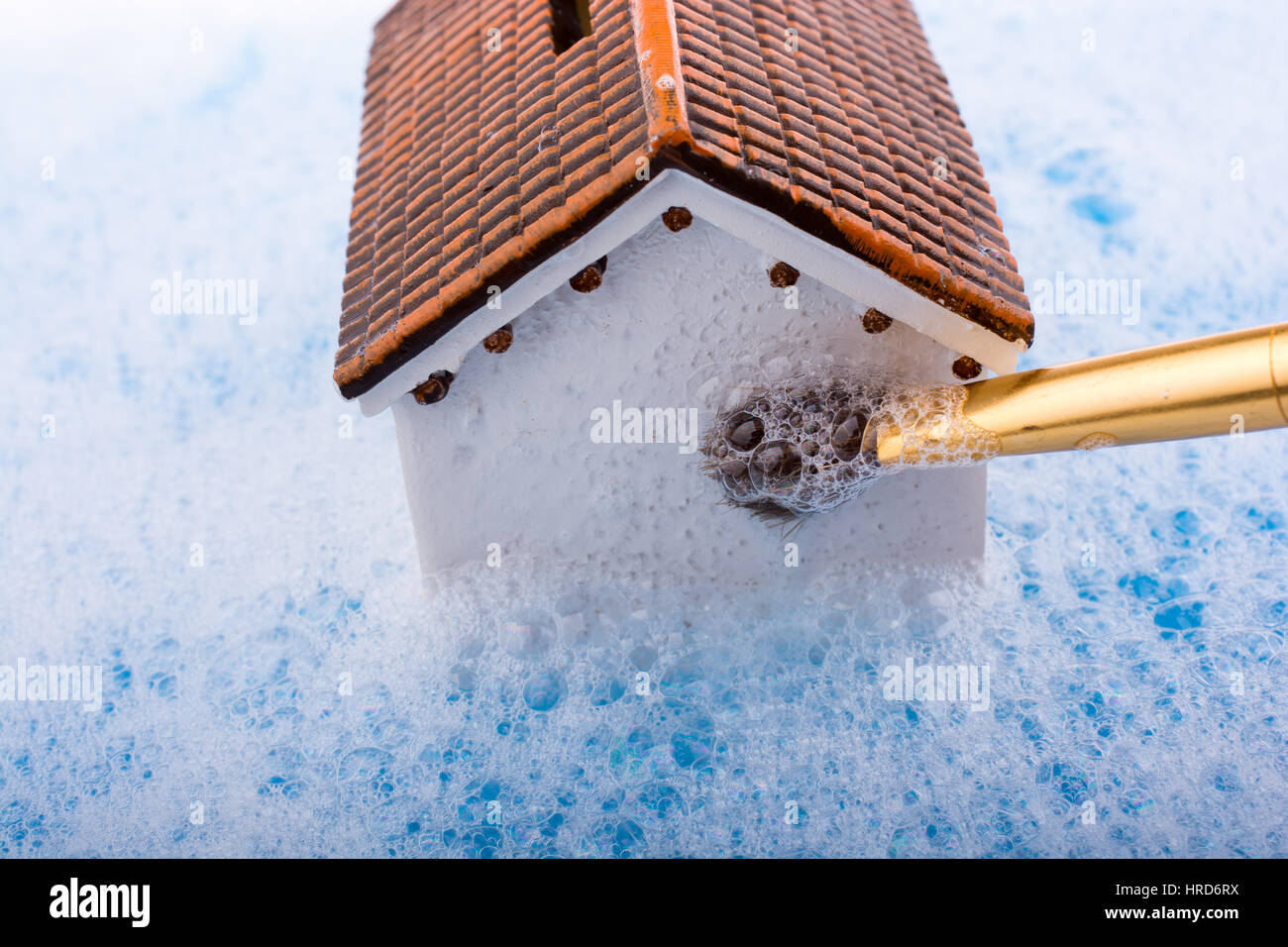 Little model house and a painting brush in foamy water Stock Photo - Alamy