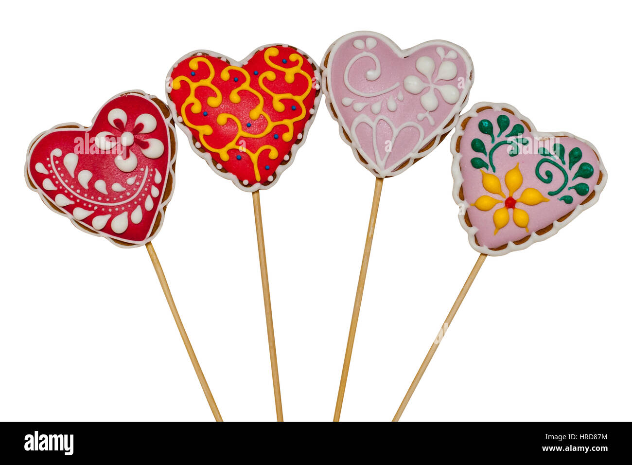 Colored cakes. Four heart shaped multicolored tasty cakes on white ...