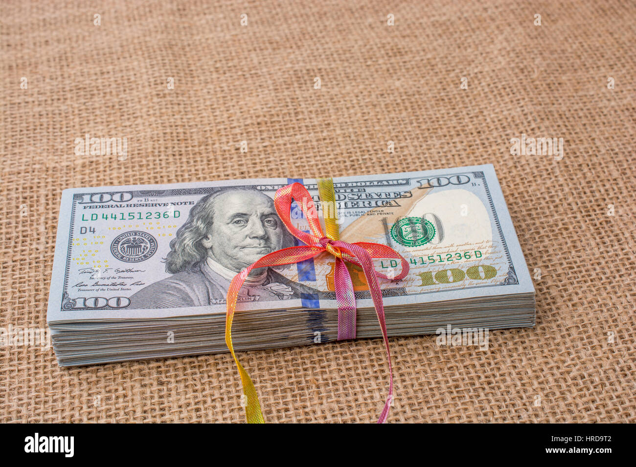 Banknote bundle of US dollar tied with colorful a ribbon Stock Photo ...