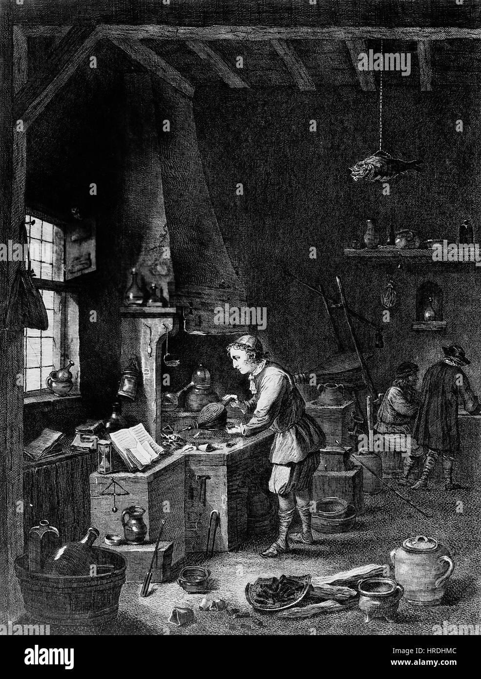 A young alchemist works a bellows at his furnace. Etching by Wellcome ...