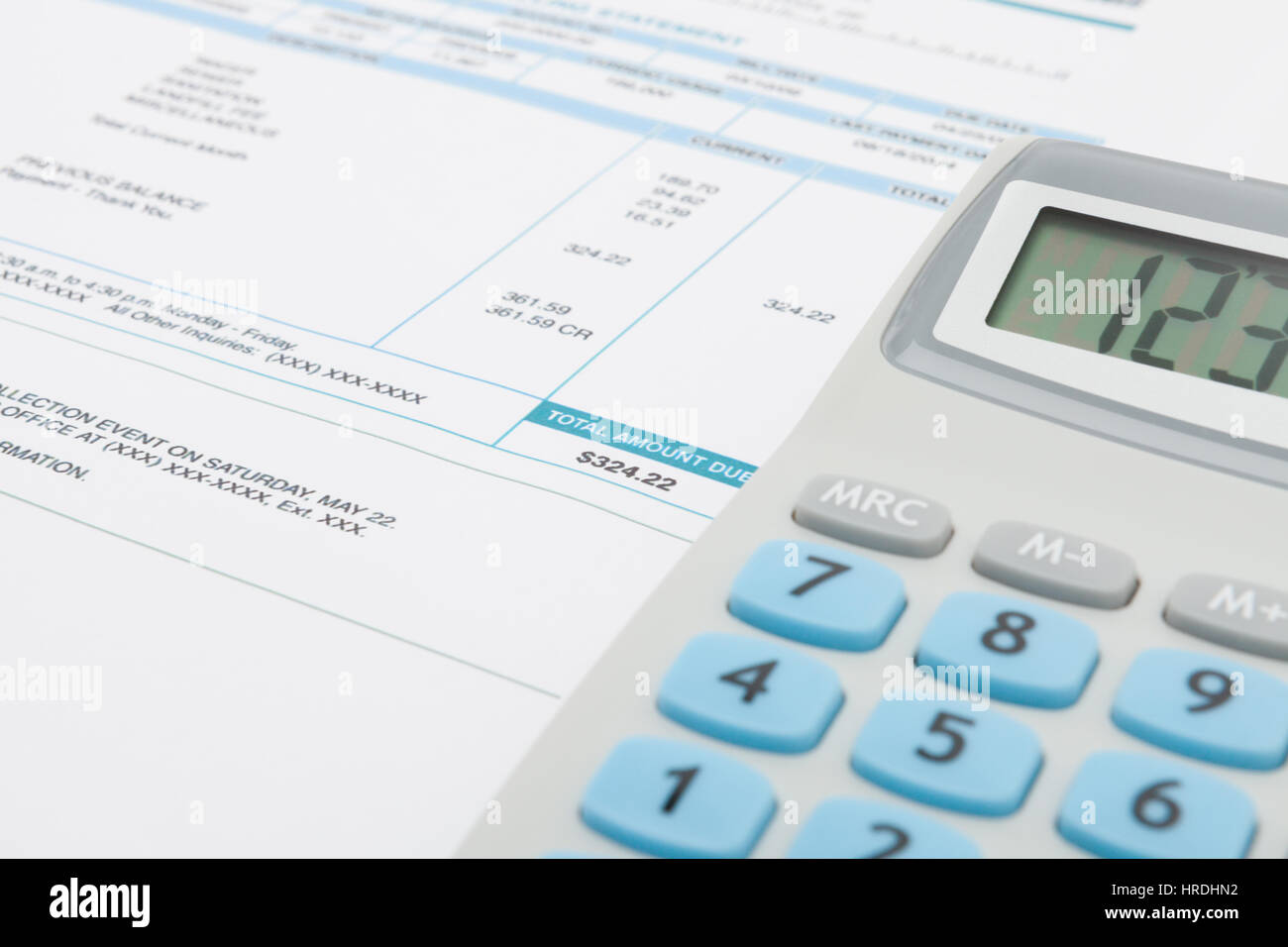 Utility bill and calculator next to it Stock Photo - Alamy