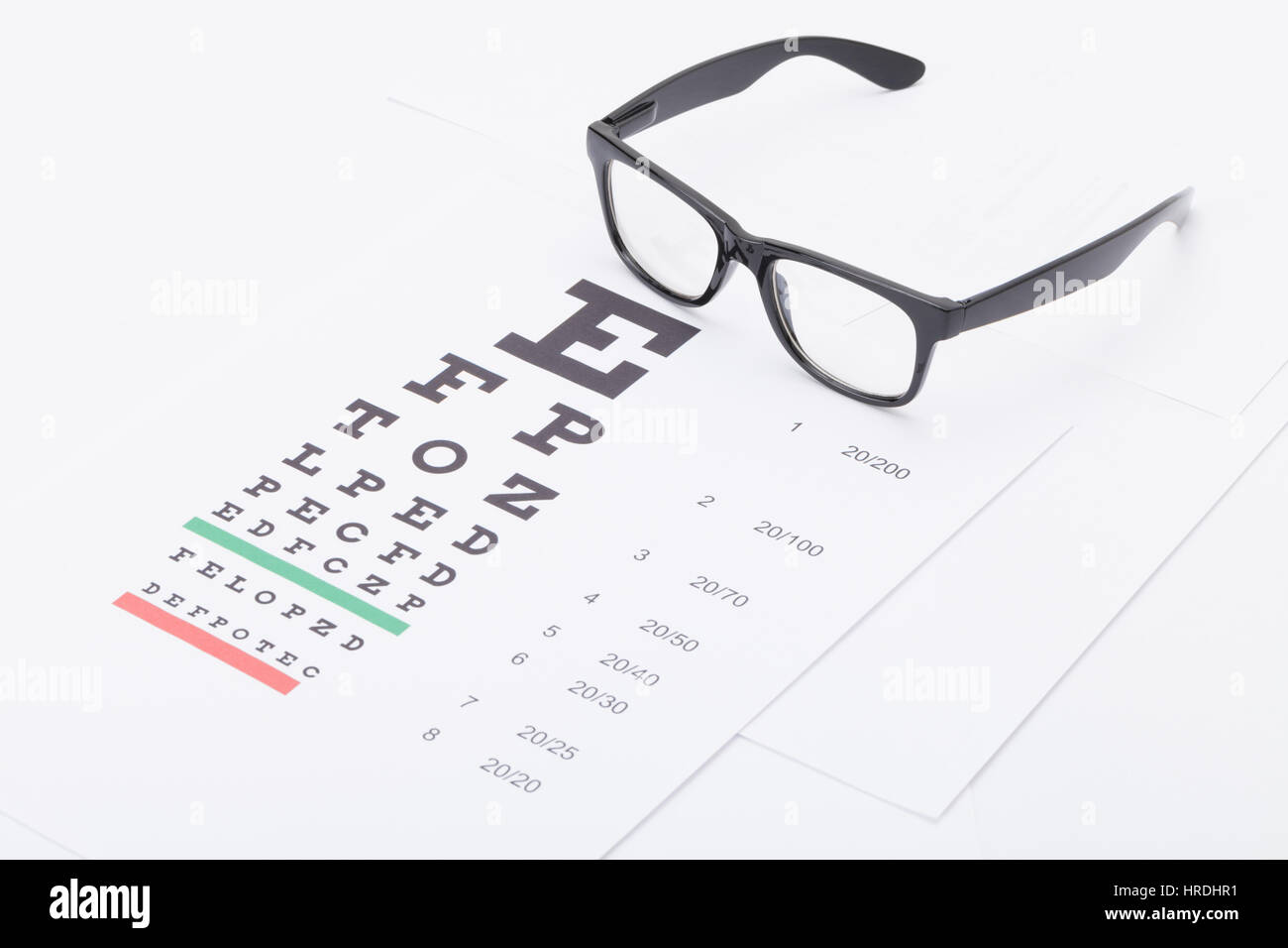 Close up studio shot of a table for eyesight test with neat glasses ...