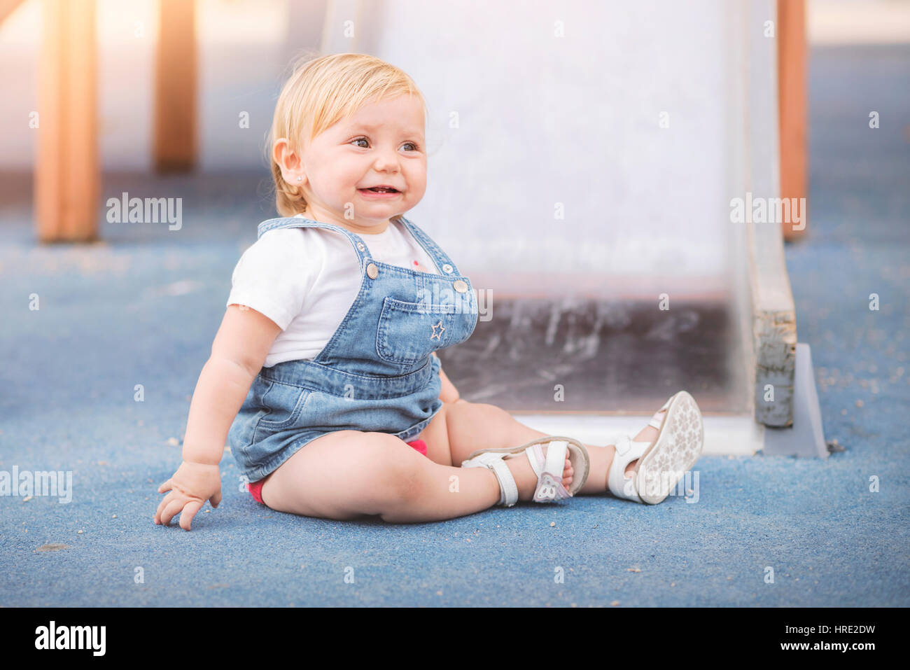 Baby in the playground Stock Photo - Alamy